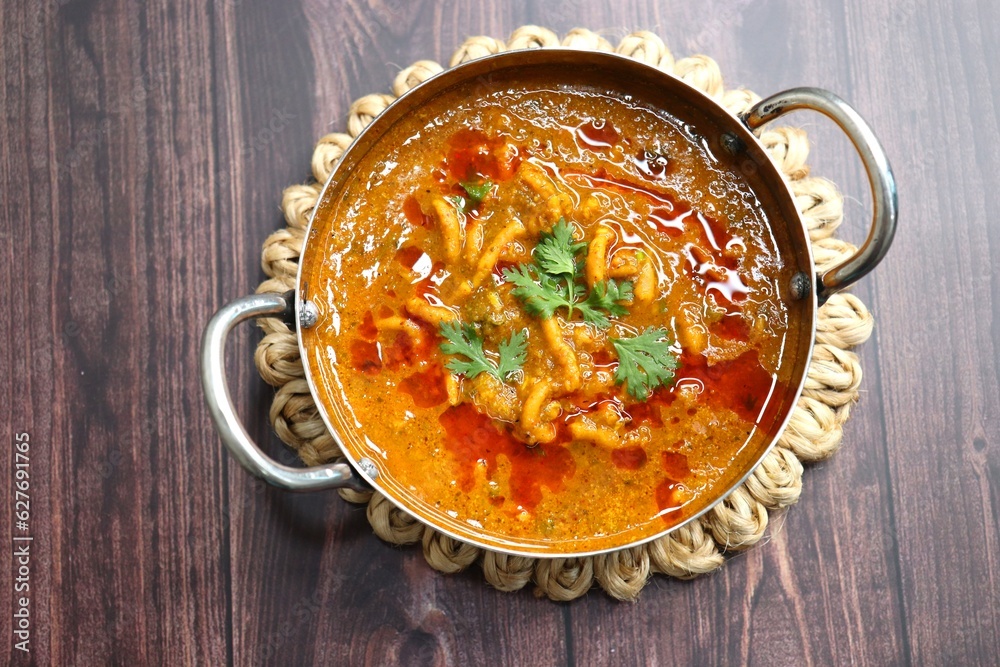 Traditional Sev bhaji or sev tamatar nu Shaak with Jowar Bhakri. Sev is ...