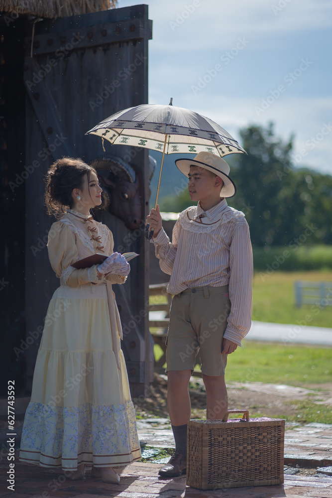 Young Asian teenage boy and girl wearing Victorian or Edwardian-era ...
