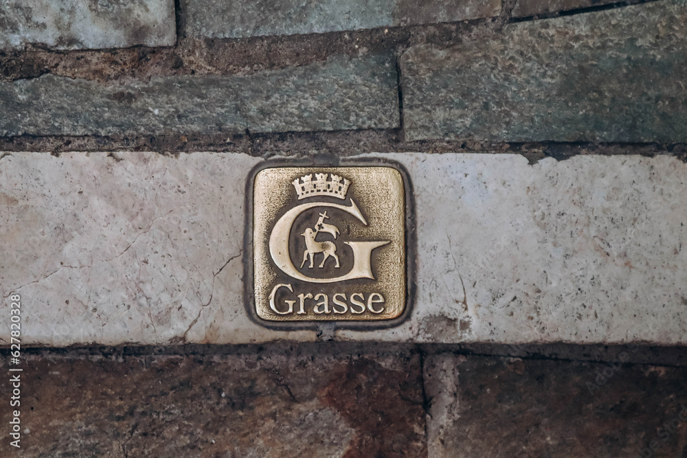 Grasse, France - July 23, 2023: Emblem of Grasse on the pavement in the ...