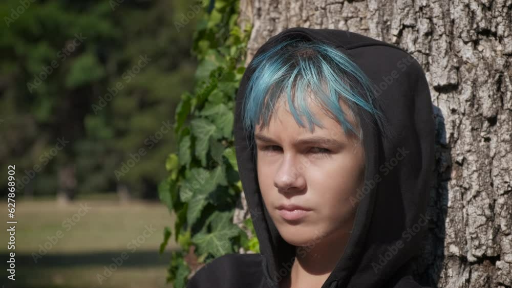 Unhappy girl feelings by tree in forest. A view of unhappy young girl ...