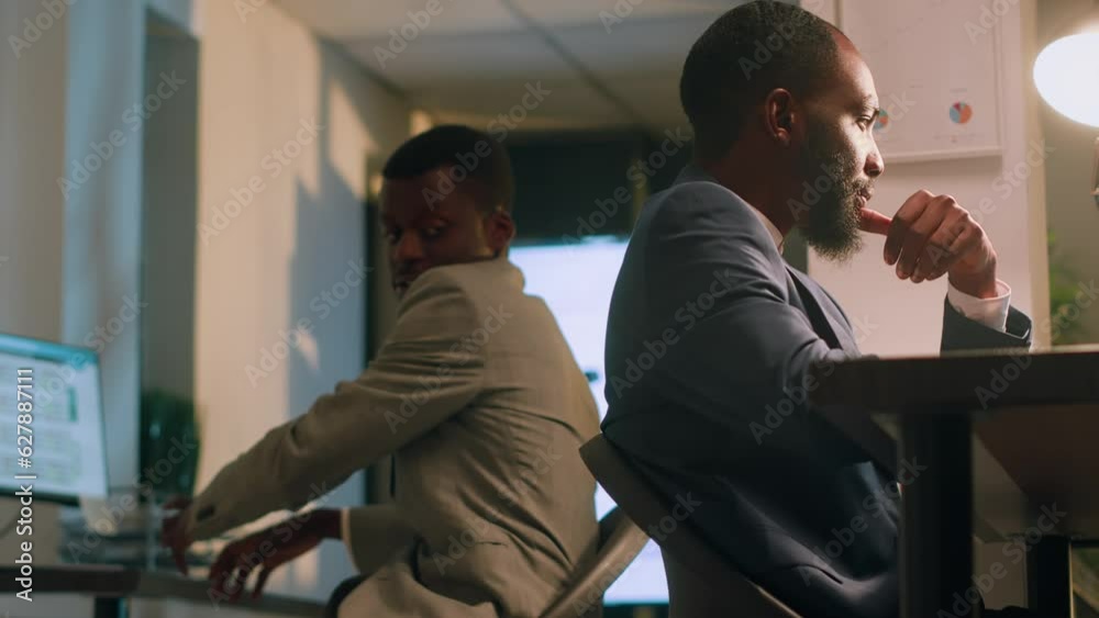 Friendly businessman having fun at work during nightshift, bumping into ...