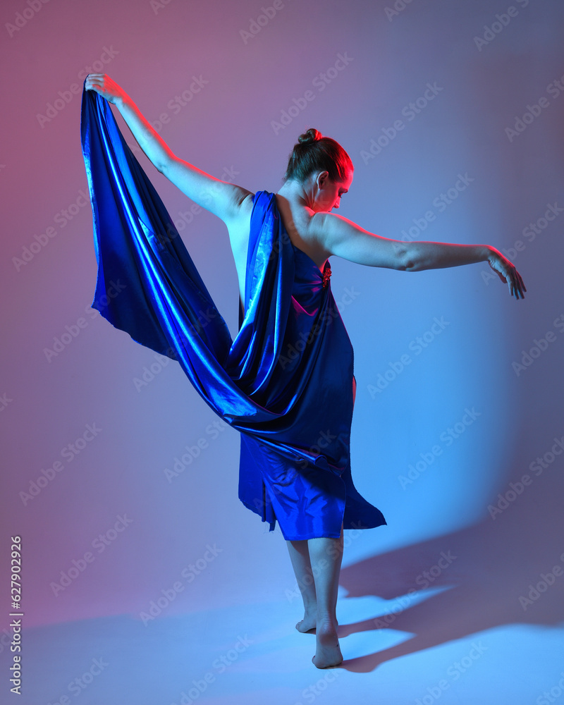 Full length portrait of beautiful female model wearing elegant flowing ...