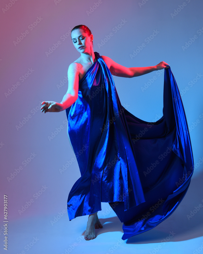 Full length portrait of beautiful female model wearing elegant flowing ...