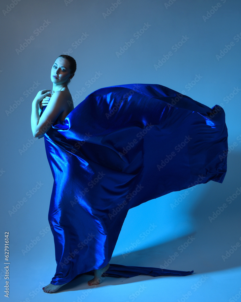 Full length portrait of beautiful female model wearing elegant flowing ...