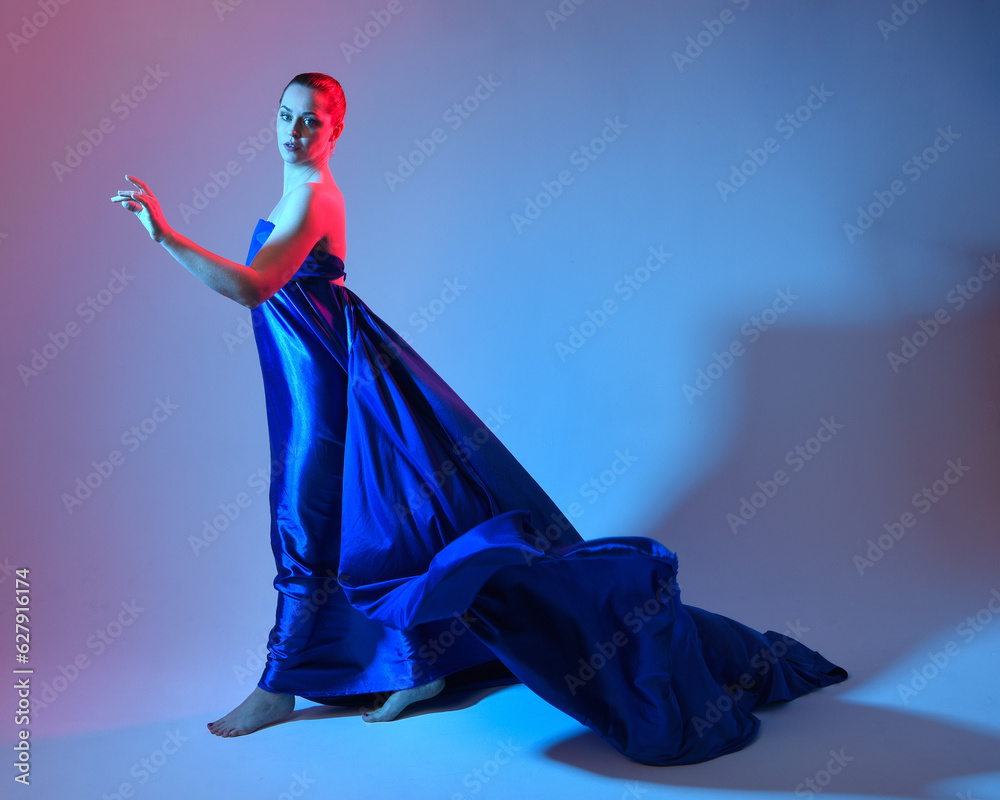 Full length portrait of beautiful female model wearing elegant flowing ...