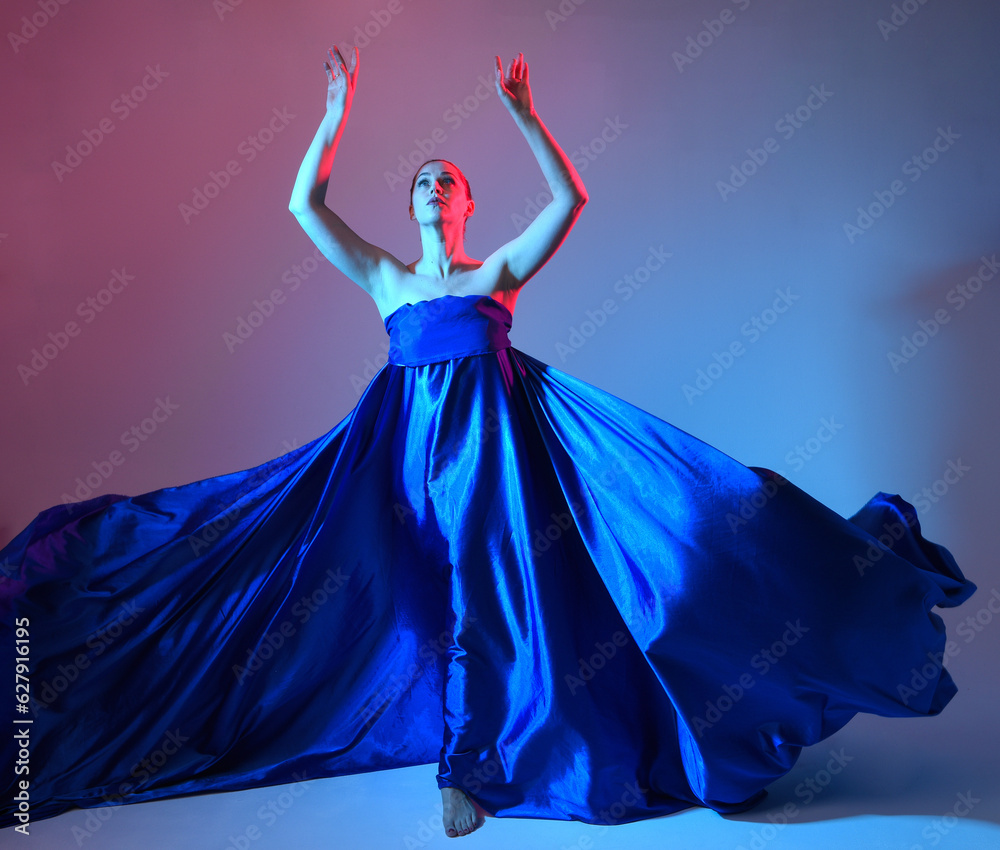 Full length portrait of beautiful female model wearing elegant flowing ...