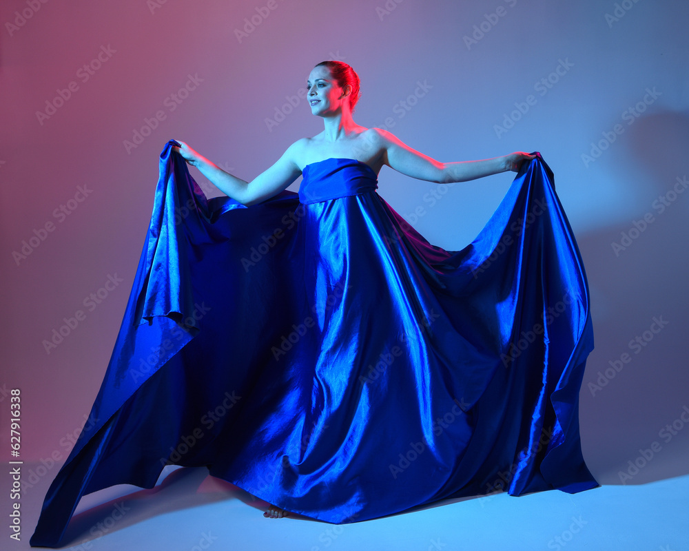 Full length portrait of beautiful female model wearing elegant flowing ...