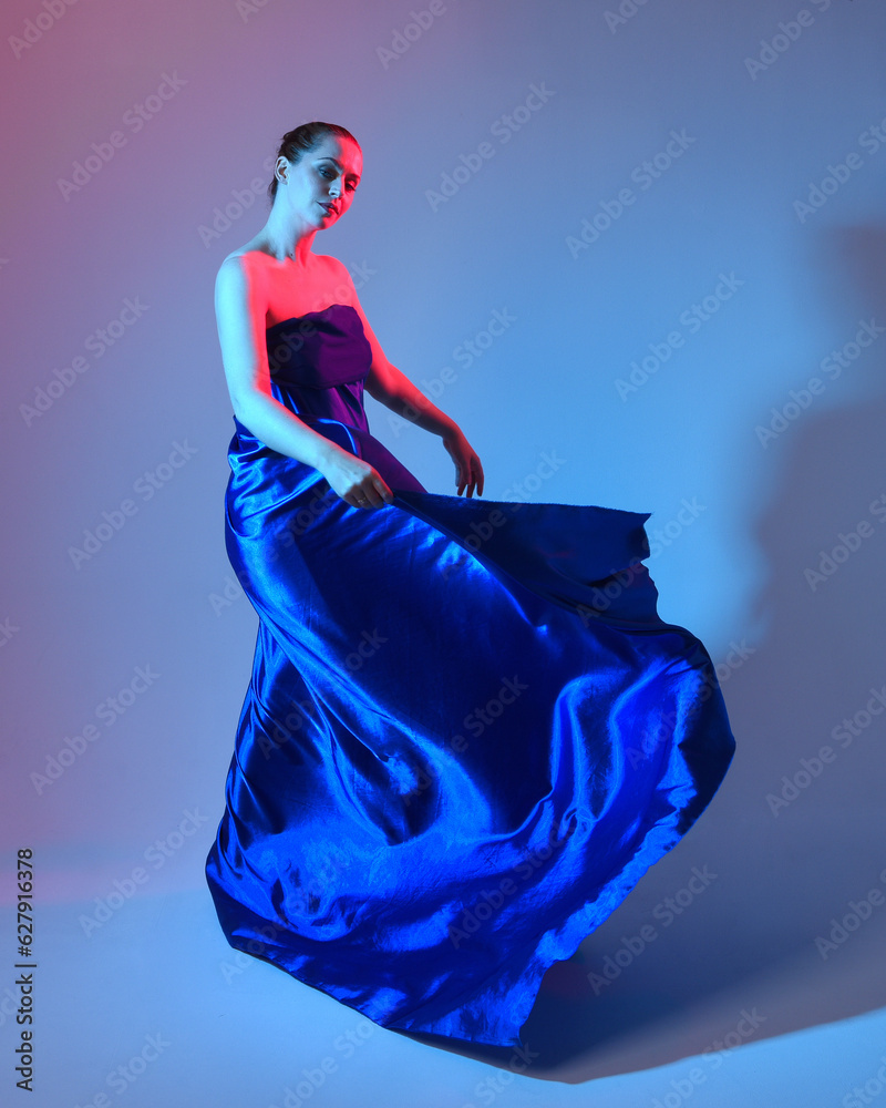 Full length portrait of beautiful female model wearing elegant flowing ...