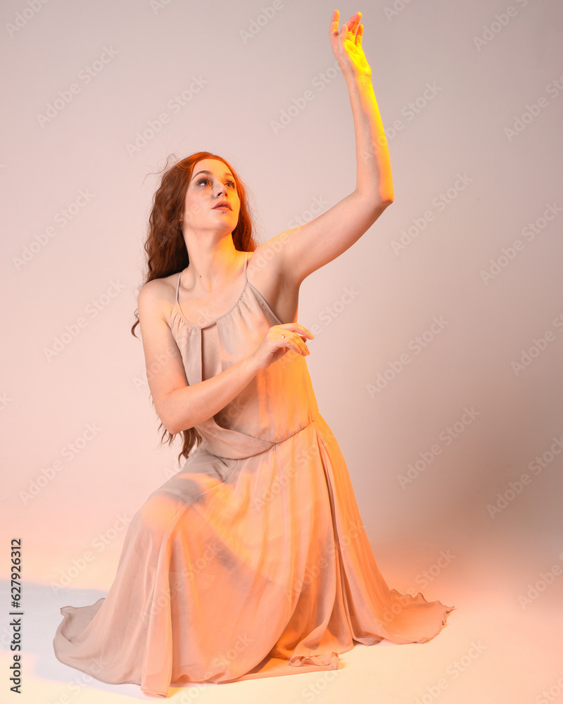 Full length portrait of beautiful brunette female model wearing dress ...