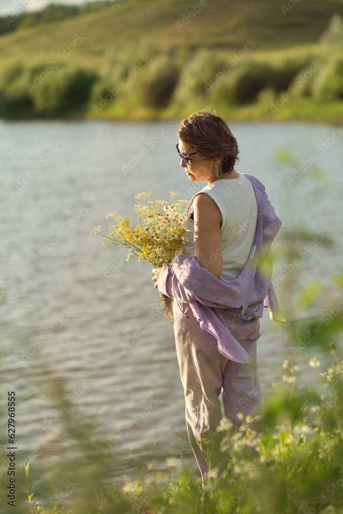thoughtful, modern retiree immerses herself in the tranquility of a ...