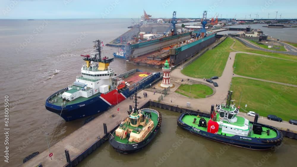 Bremerhaven - ship dock is pulled by the deep-sea tugboat - an aerial ...