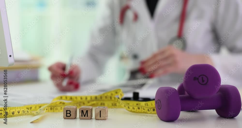 Tape for measuring dumbbells and the word BMI in doctor. Ratio of ...
