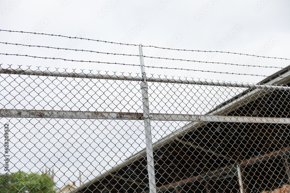 Chain-link fence symbolizes boundaries, security and isolation ...