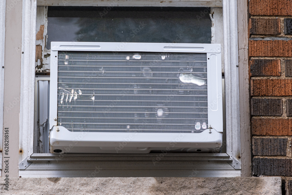 climate change: old window air conditioning unit in an older building ...