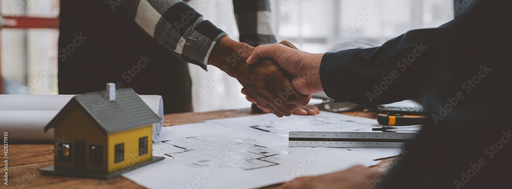 Architects and engineers working together and handshake business ...