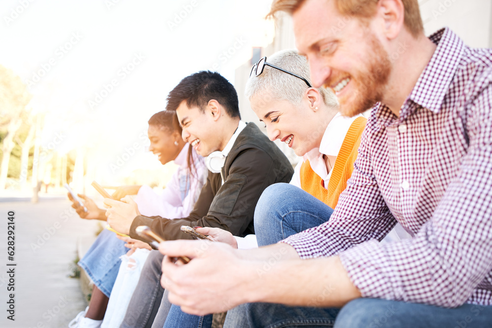 Technology Addicted smiling group of students using mobile phones. They ...