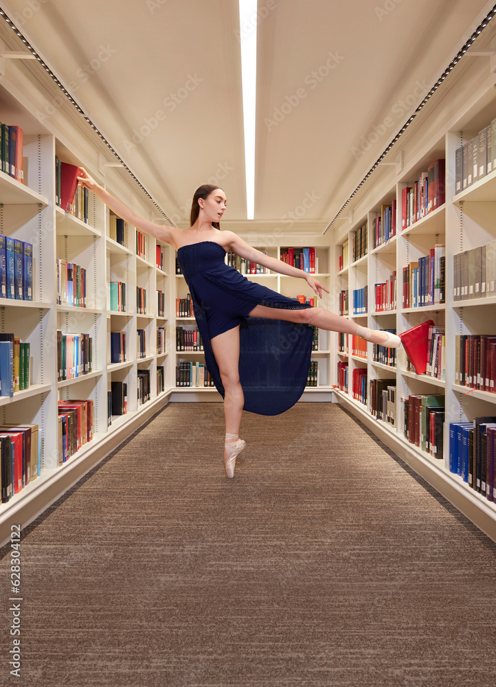 Young female ballerina striking pose in library pulling one book out ...