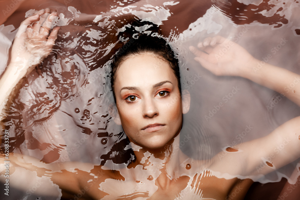 Underwater beauty portrait of a beautiful caucasian girl. Looking in ...