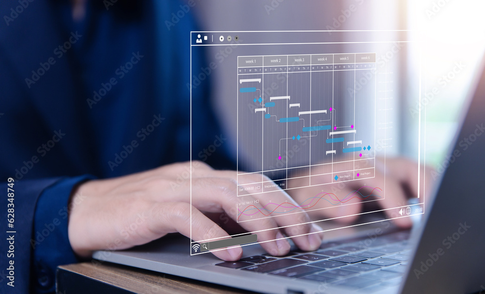 business manager managing business planning project schedules in the office. Gantt chart showing ...