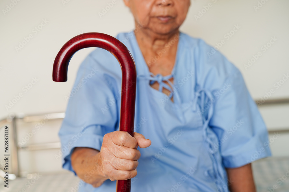 Asian elderly disability woman patient holding walking stick in ...