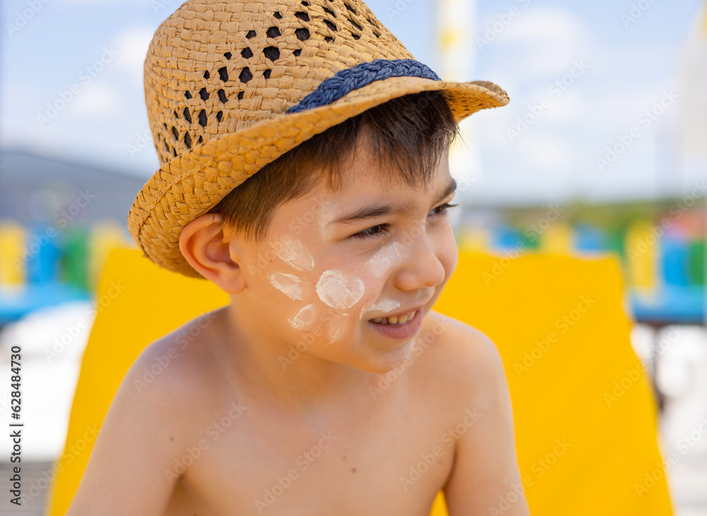 adorable preschooler kid boy with sun shape drawn from spf protection ...