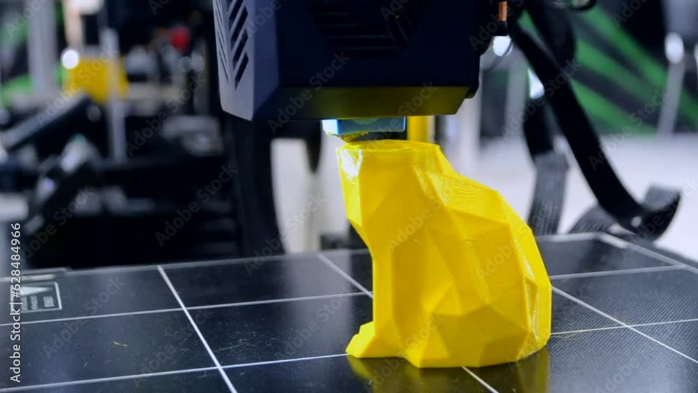 3D printer printing prototype of toy from molten plastic. Process of ...