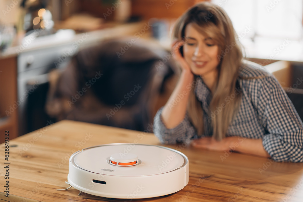 Vacuum Robot cleaning at home. Robot vacuum cleaner in the modern home ...