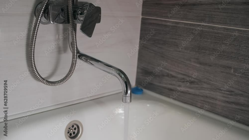 Tap water jet, close up. Metal faucet in shower with powerful jet of ...