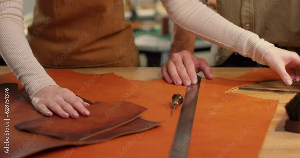 Male and female tanners choosing and looking craft for handwork ...