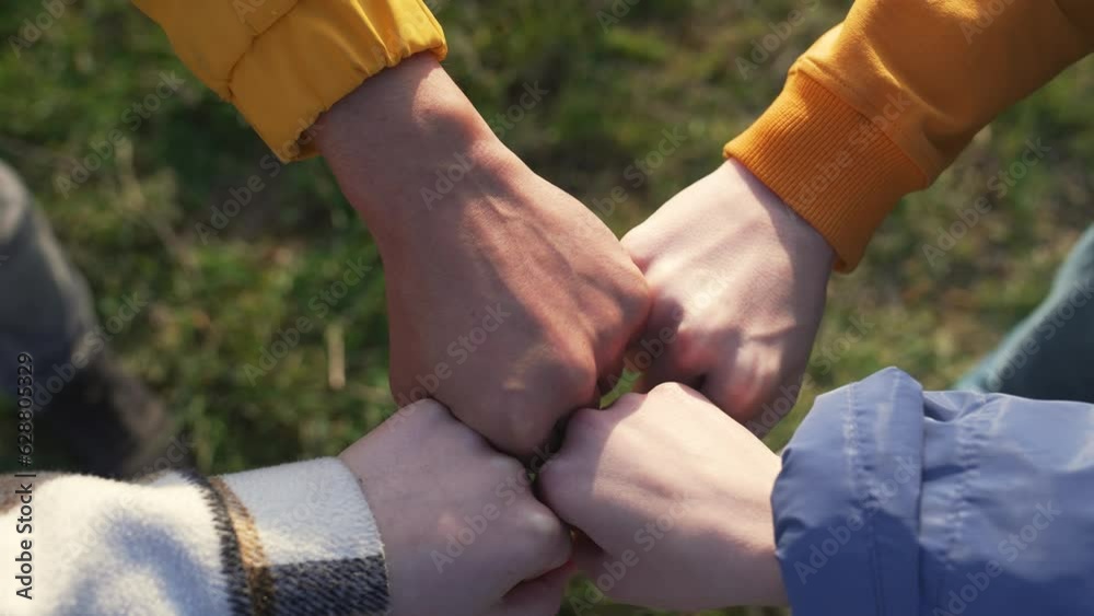 Teamwork.Group of people partners hitting their fists together ...