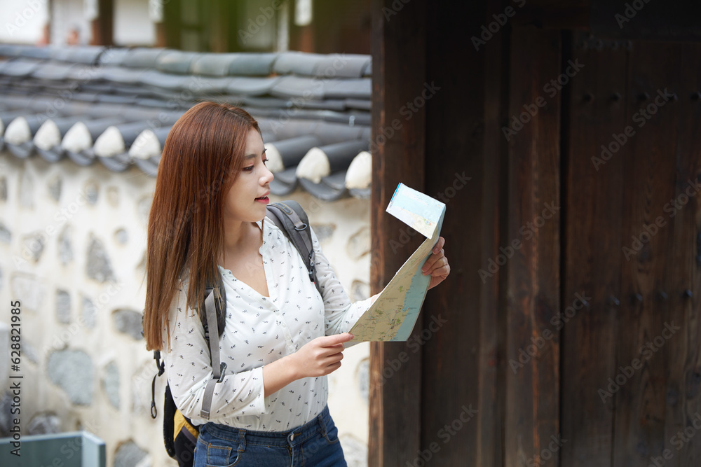 A young female college student who is looking for her way while looking ...