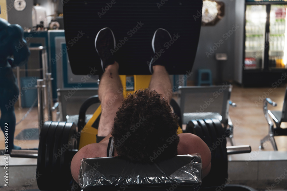 heavy workout gym with multiple equipment randomly working out in a gym ...