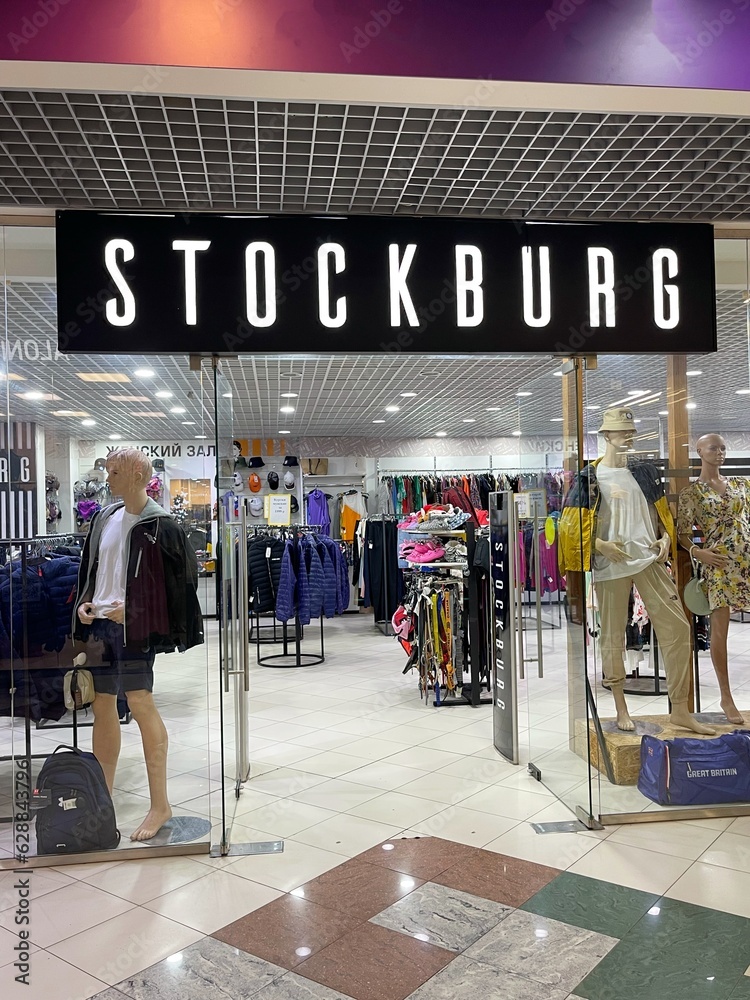 Shop of discount clothes Stockburg. Sign with name of store above ...