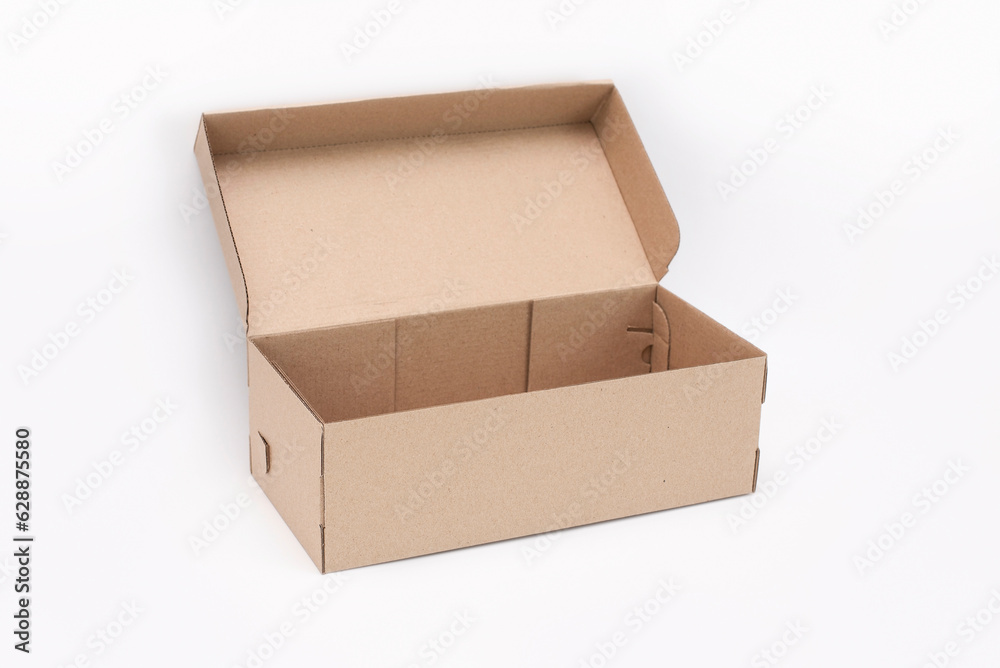 A cardboard box for shoes on a light background. Corrugated box open ...