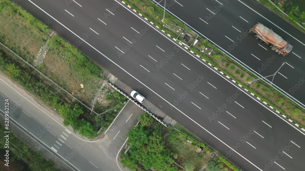 Aerial view of a highway with vehicles. Fly-over shot of an expressway ...