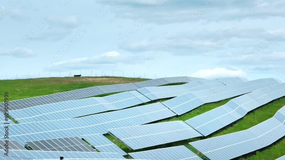 Blue photovoltaic solar panels mounted in the field for producing clean ...
