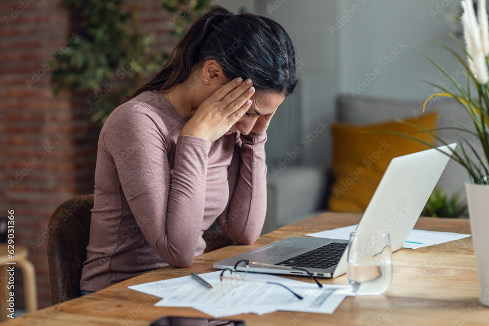 Beautiful young woman with headache while working with pc Stock Photo ...