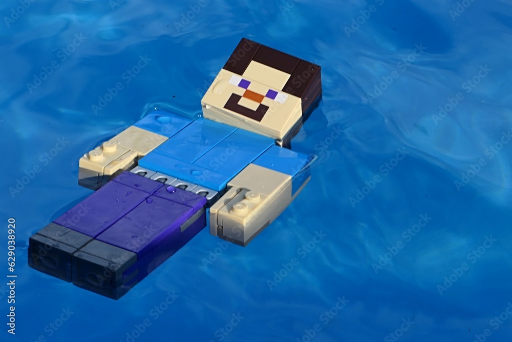 LEGO Minecraft figure of smiling Steve swimming backstroke in swimming ...