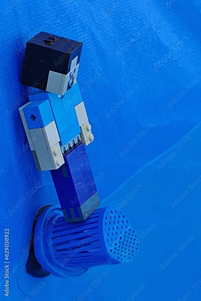 LEGO Minecraft figure of smiling Steve standing on small round swimming ...