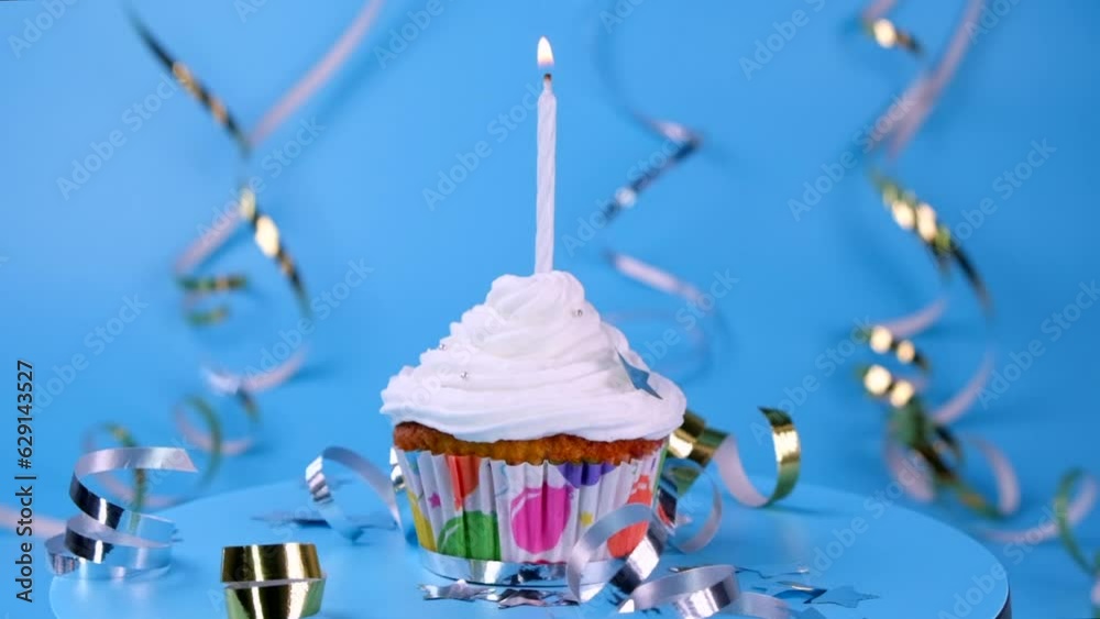 Rotating birthday cake for a boy or man or a cupcake with a burning ...