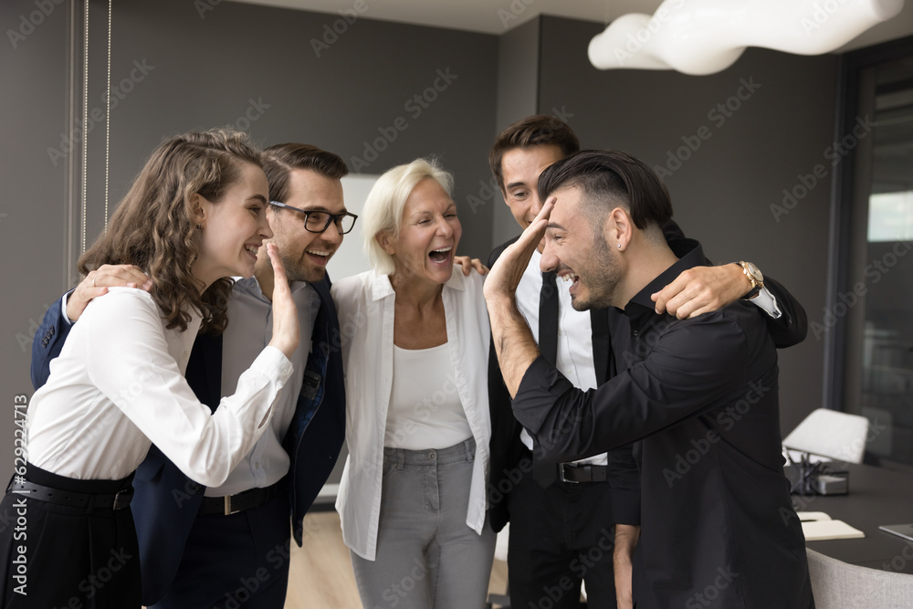 Cheerful energetic team of younger and older professionals giving group ...