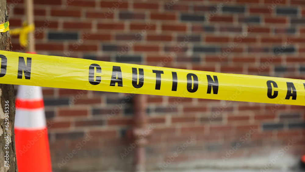 yellow caution tape signals danger and restriction. Its bright color ...