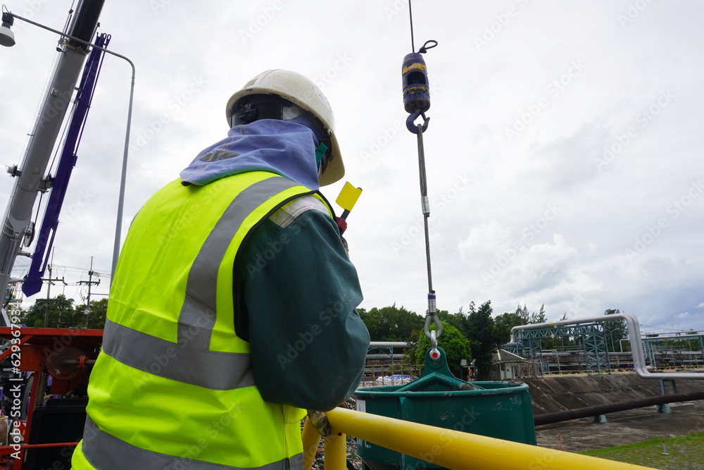Worker or rigger during lifting deformed bars by using hand signal ...