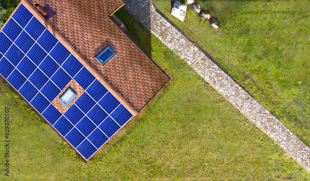 Solar panels on roof. Country cottage top view. Eco photovoltaic panels ...