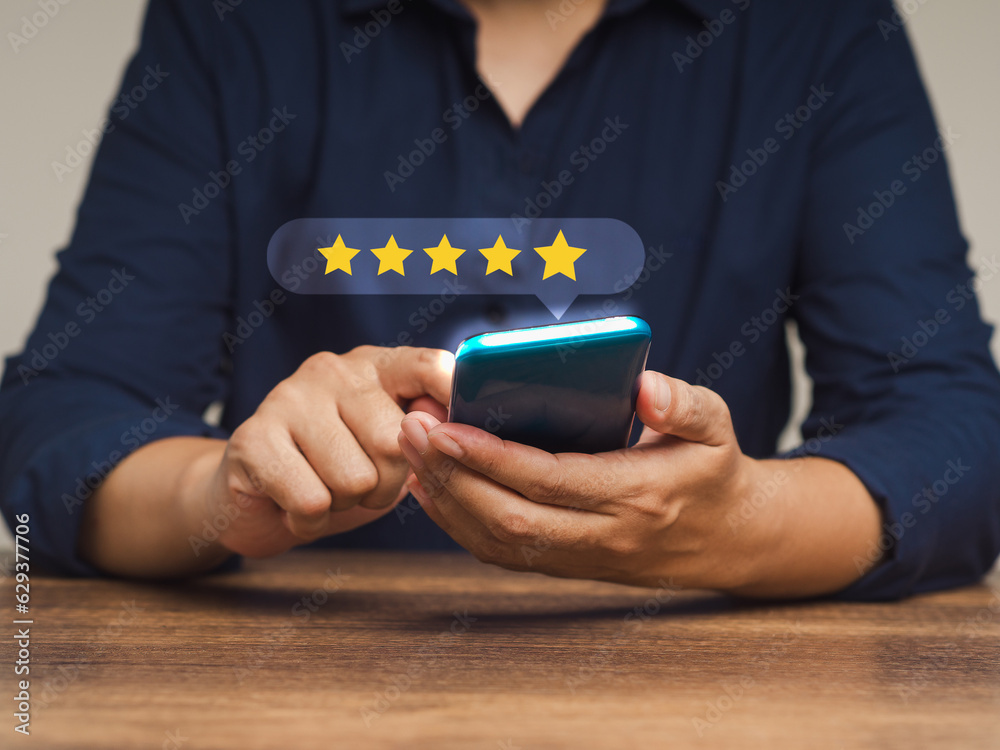 Satisfaction and feedback surveys. Customer using a smartphone gives ...
