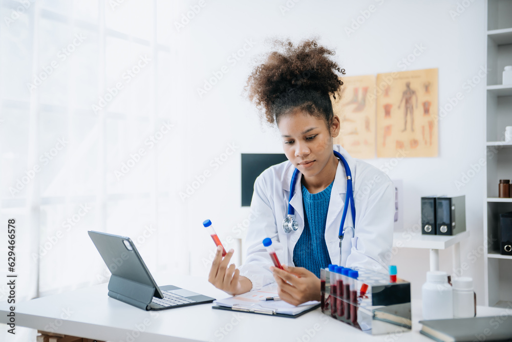 Beautiful physician doctor sit on table in office hospital. Attractive ...