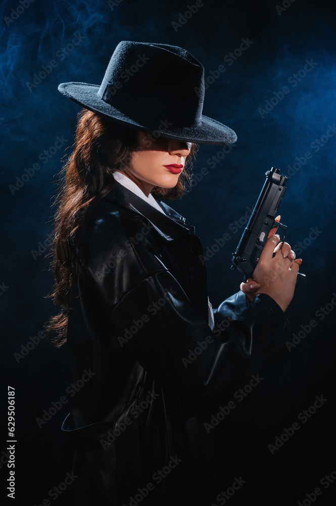 Silhouette: a female detective in a coat and hat with a gun in her ...