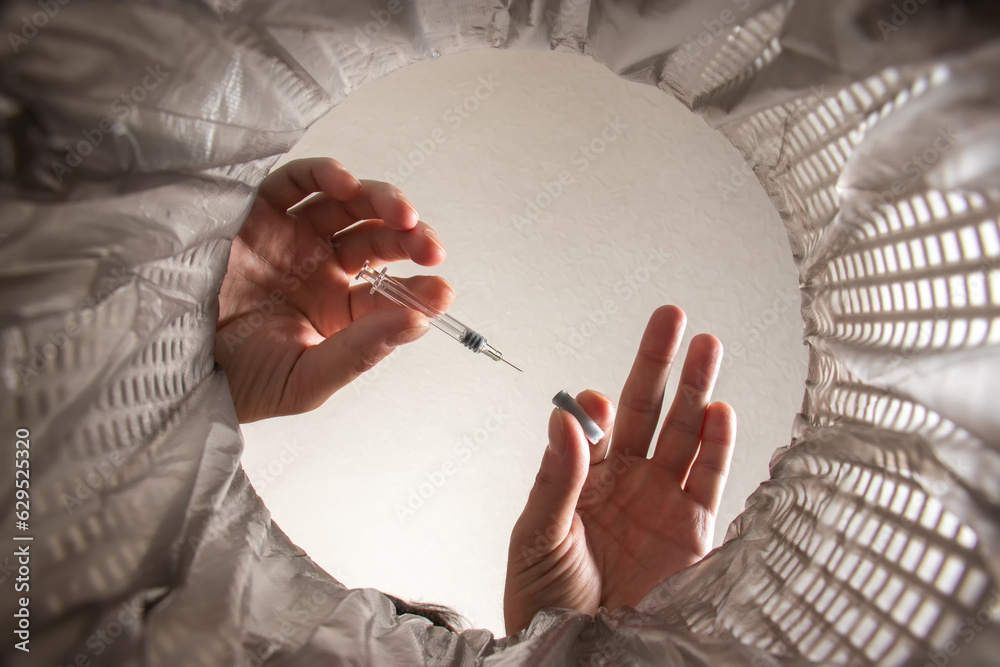 Hand throws syringe into trash bin with package. Inside view Stock ...