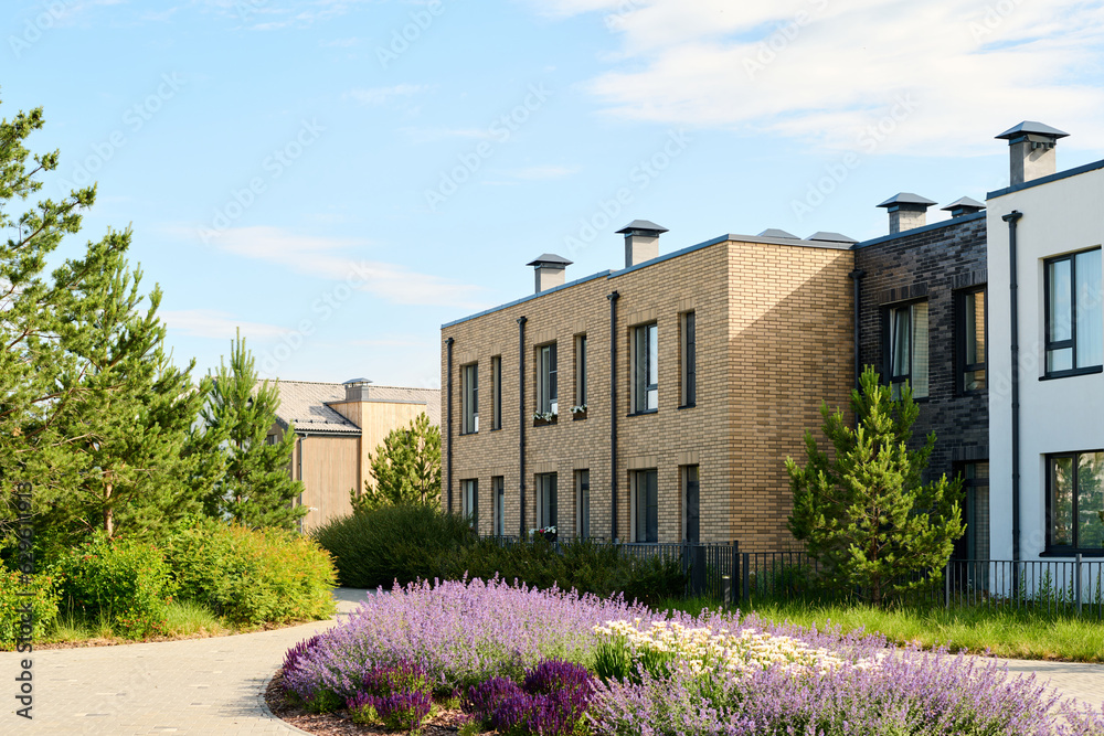 Group of small two storey residential buildings standing in row in ...
