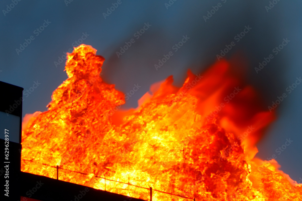 Burning building. Fire. Wildfire. Burning house. Roof of building in ...